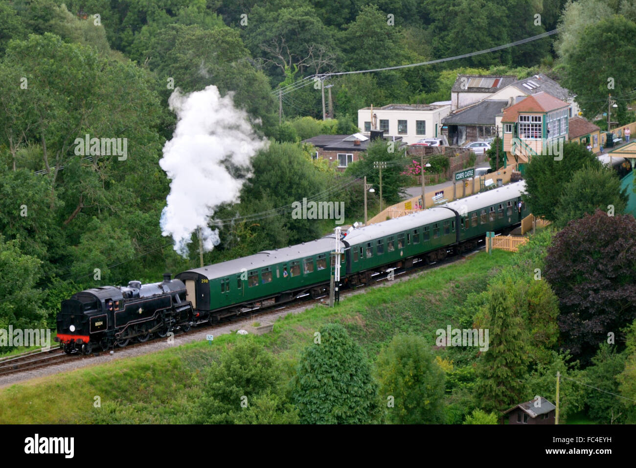 Steam train leaving Corfe Castle Station Stock Photo - Alamy