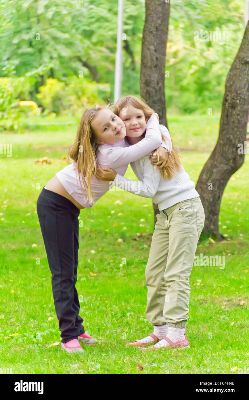 Cute two embracing girls Stock Photo - Alamy