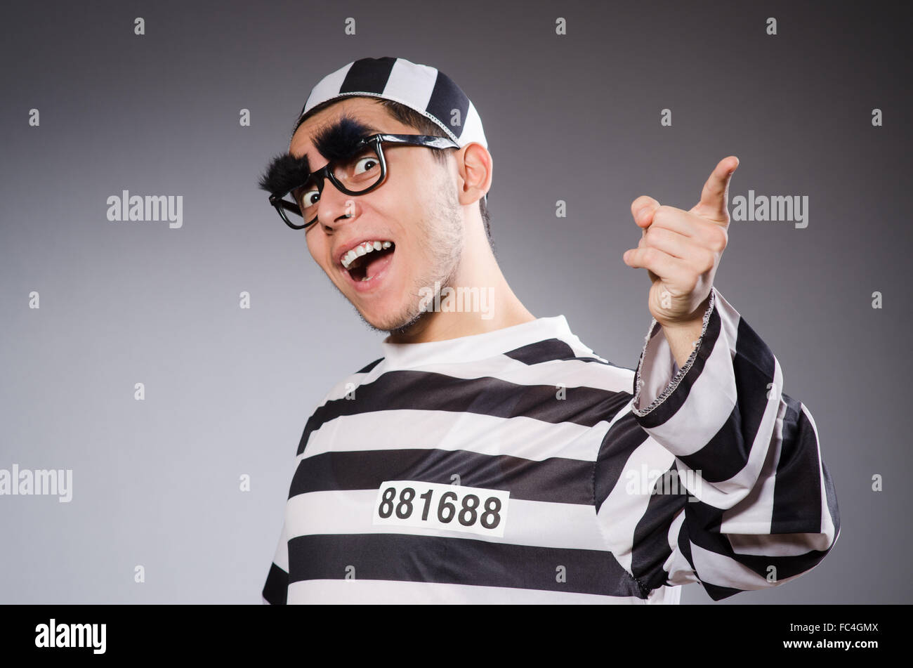 Funny prisoner isolated on gray Stock Photo - Alamy