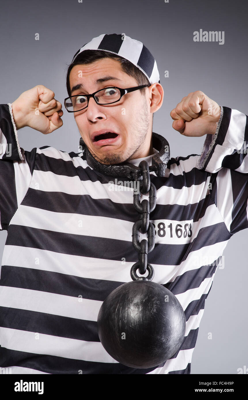 Funny prisoner in chains isolated on gray Stock Photo - Alamy
