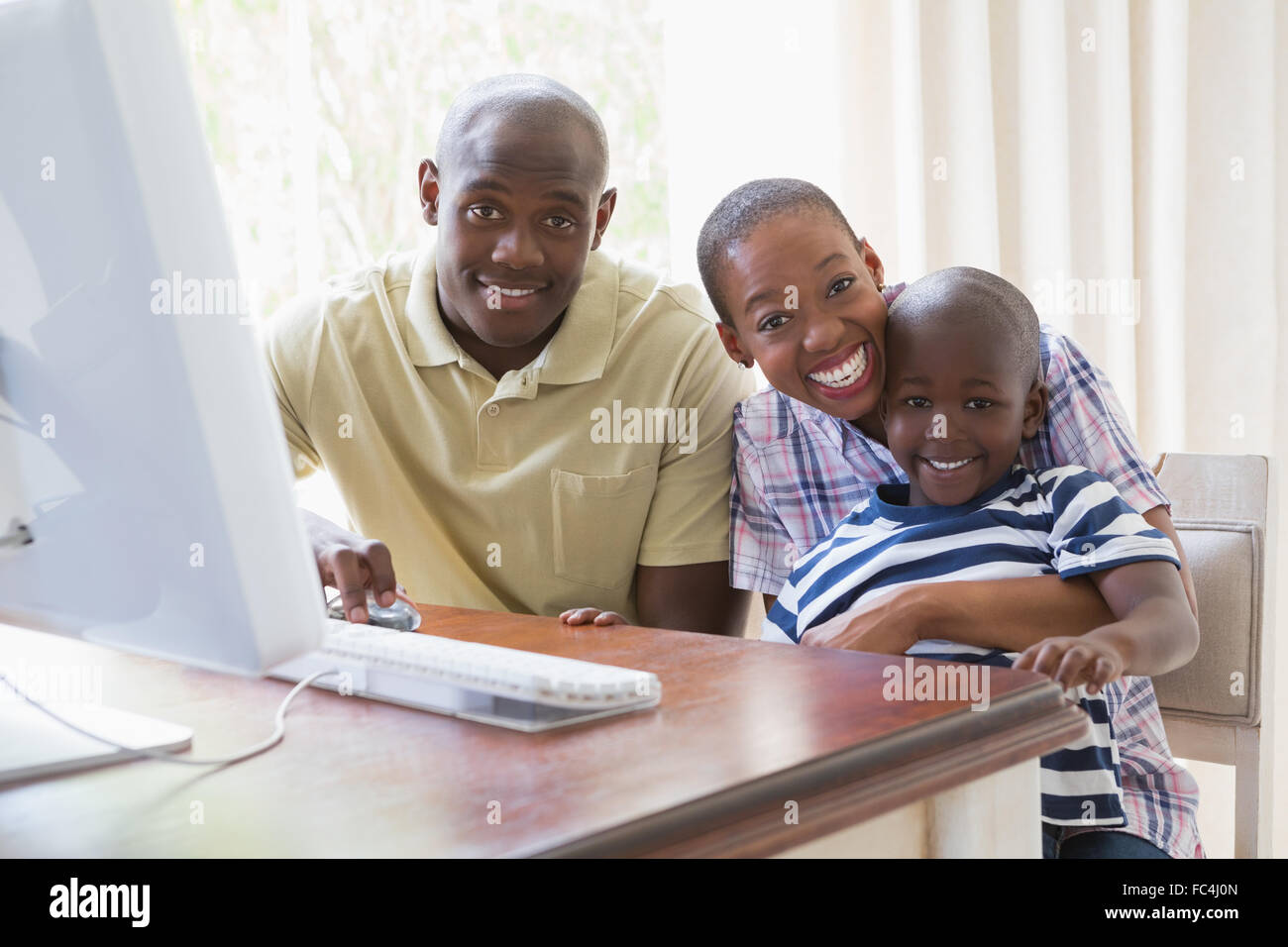Portrait of happy smiling family using computer Stock Photo - Alamy