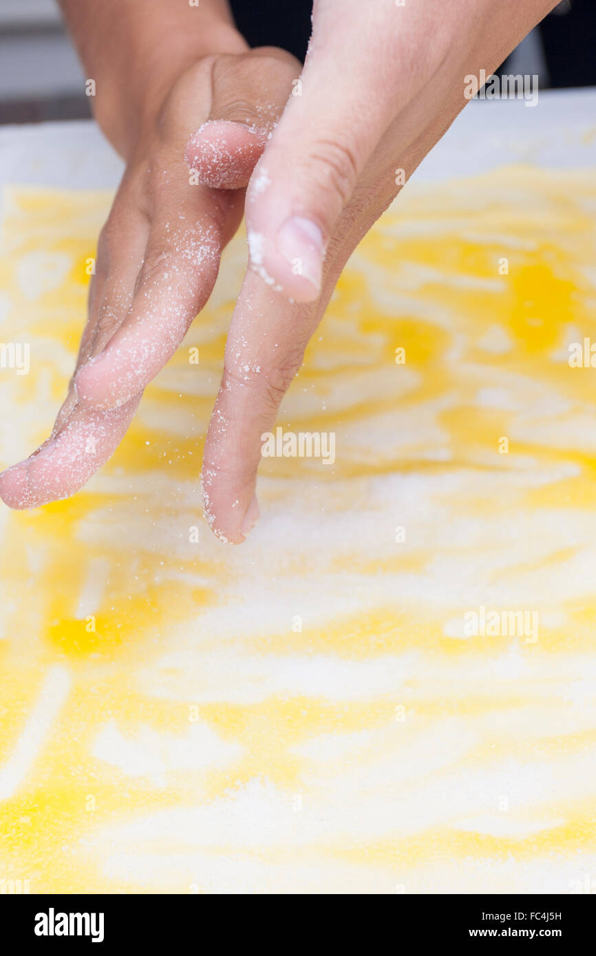 Adding sugar as ingredient to make dessert Stock Photo - Alamy