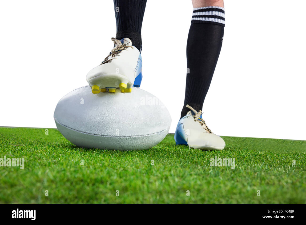 Rugby player posing feet on the ball Stock Photo - Alamy