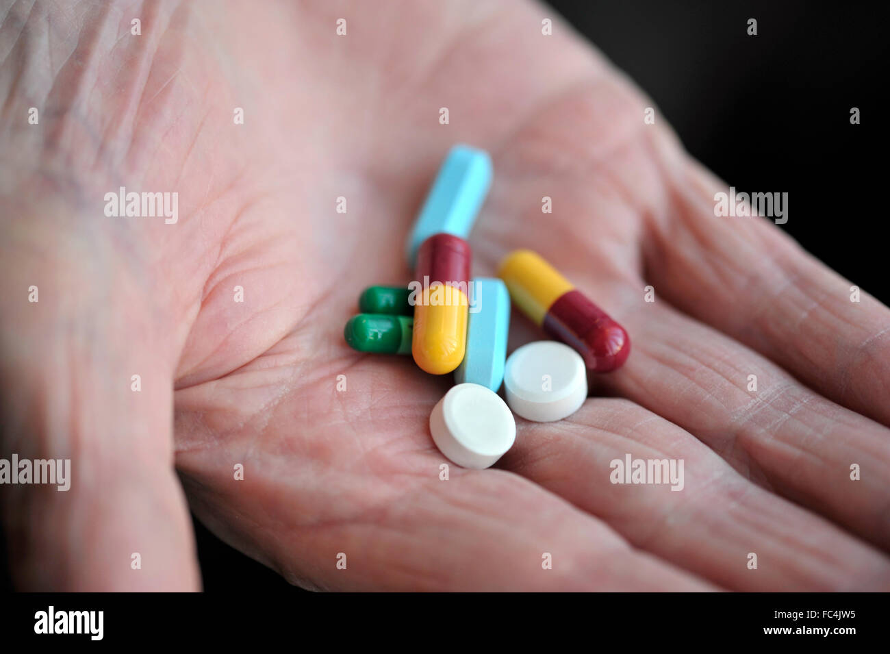 Medicines, drugs in the hand of a an old man Stock Photo - Alamy