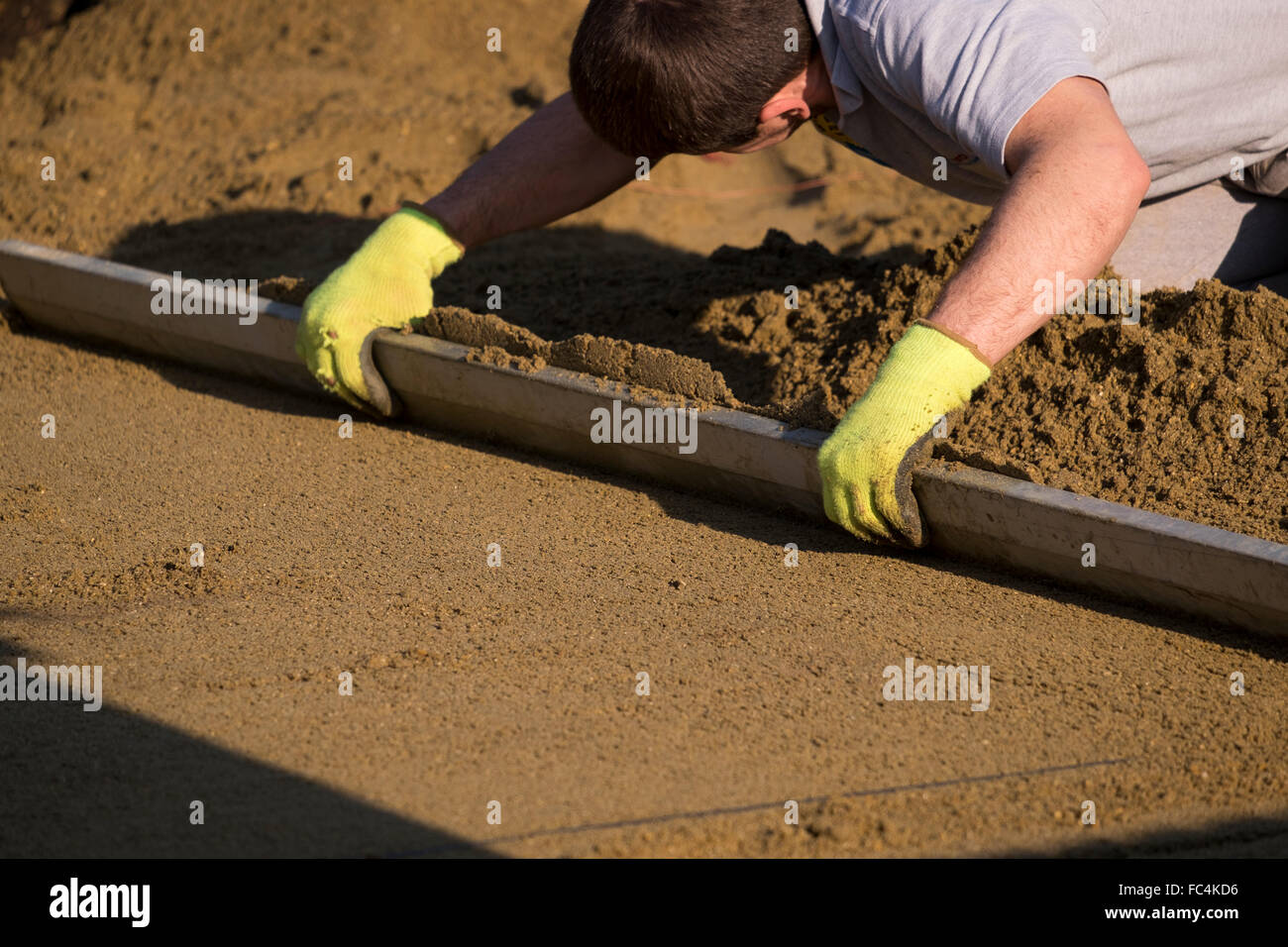 close up of drive laying specialist laying sand screed base in ...