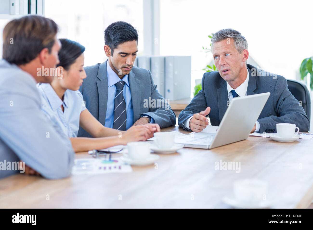 Business people speaking together during meeting Stock Photo - Alamy