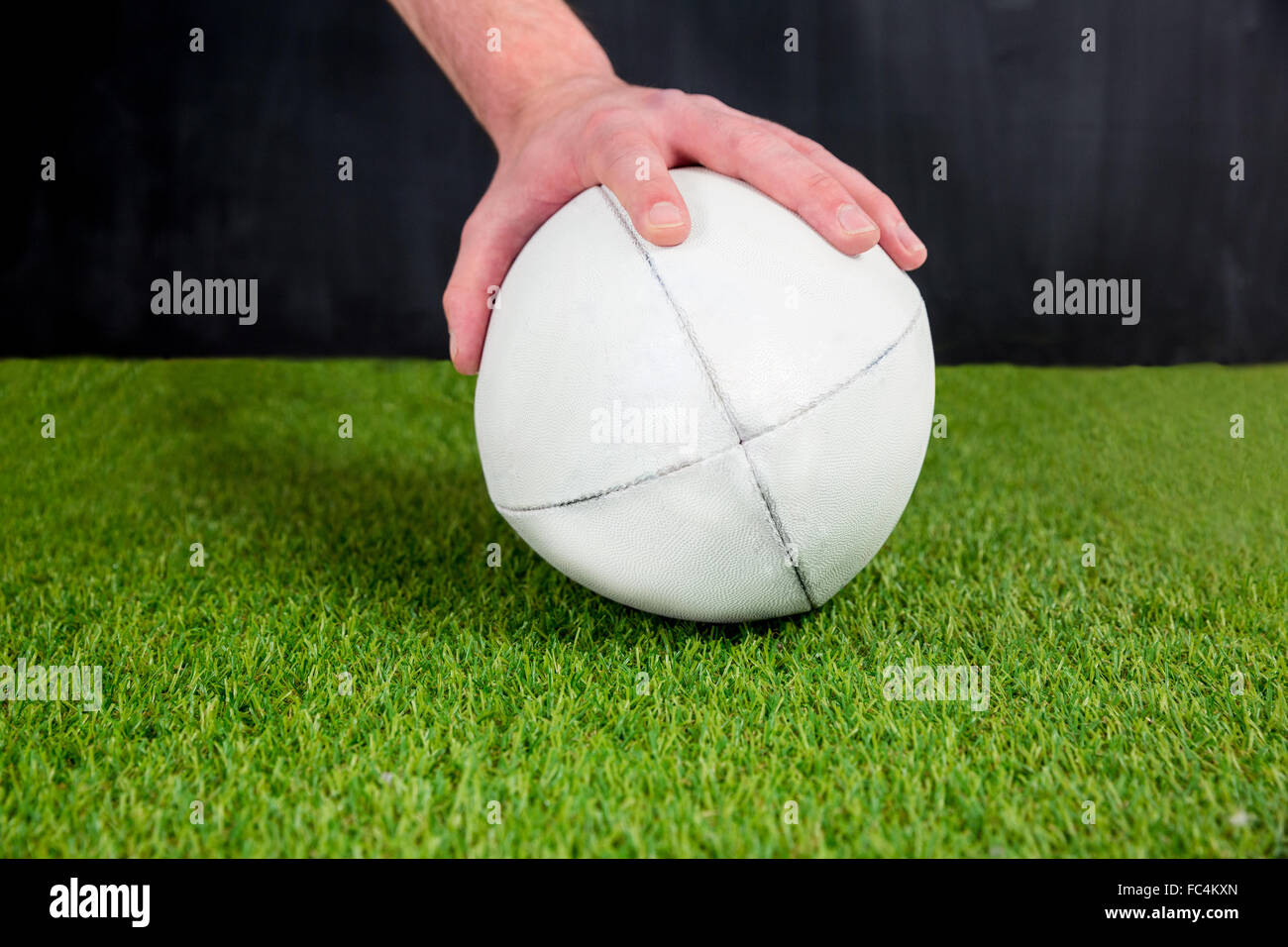 A rugby player posing a rugby ball Stock Photo - Alamy