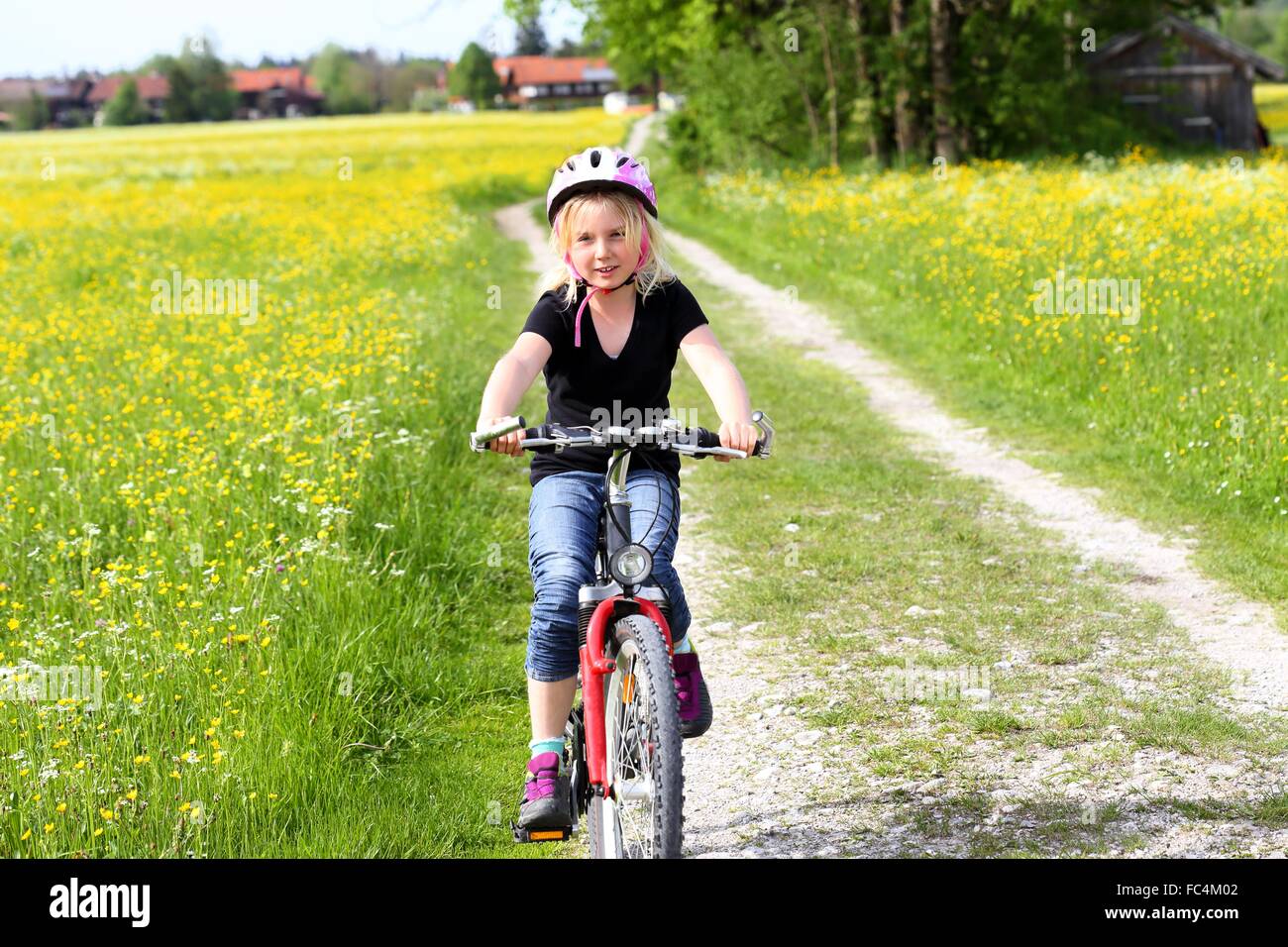 girl drives on bicycle Stock Photo - Alamy