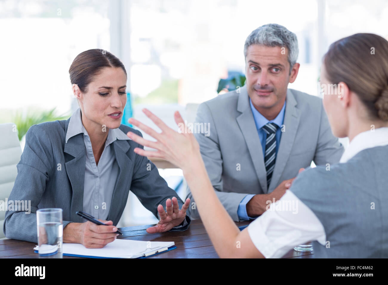 Business people interviewing young businesswoman Stock Photo - Alamy