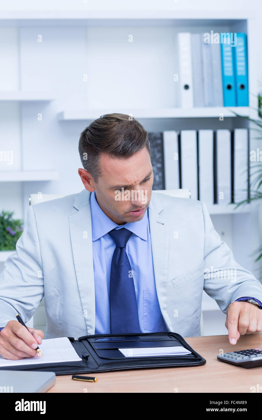 Professional businessman doing some calculations Stock Photo - Alamy