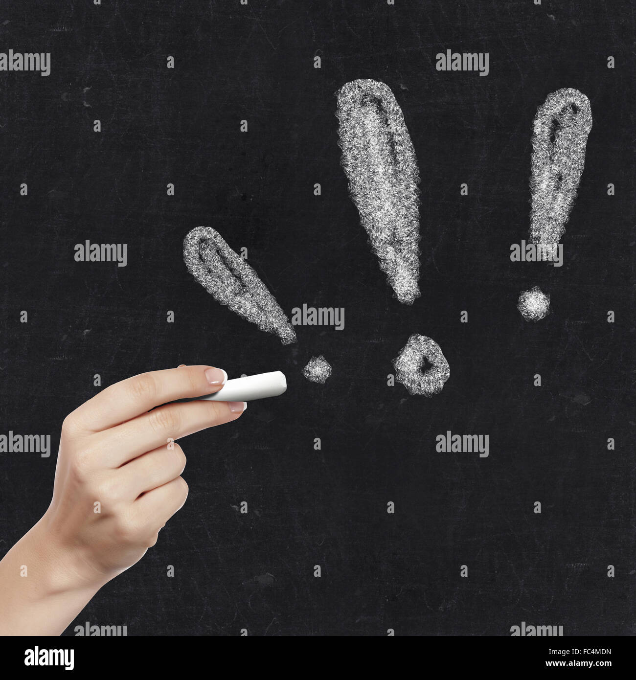 School blackboard and hand with chalk writing exclamation signs on it ...