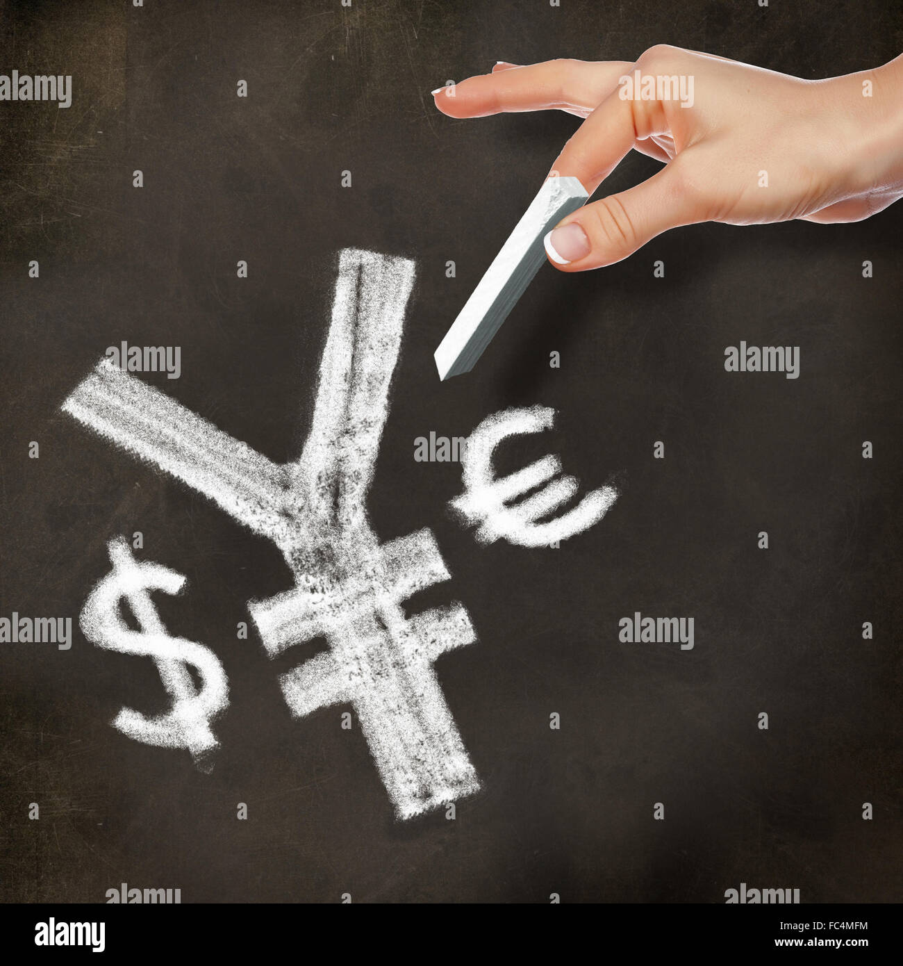 School blackboard and hand with chalk writing currency symbols on it ...