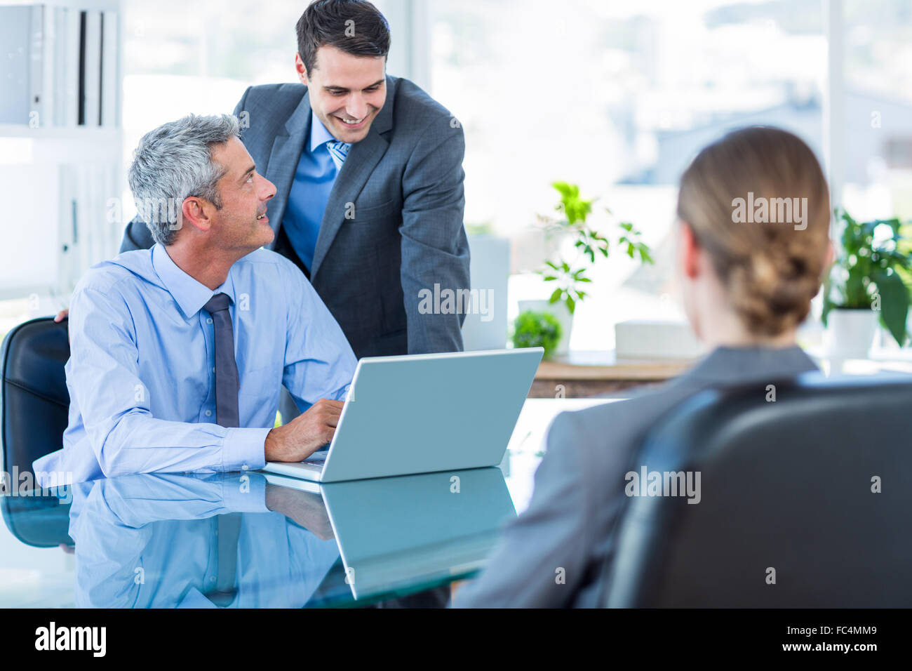 Business people speaking together during meeting Stock Photo - Alamy