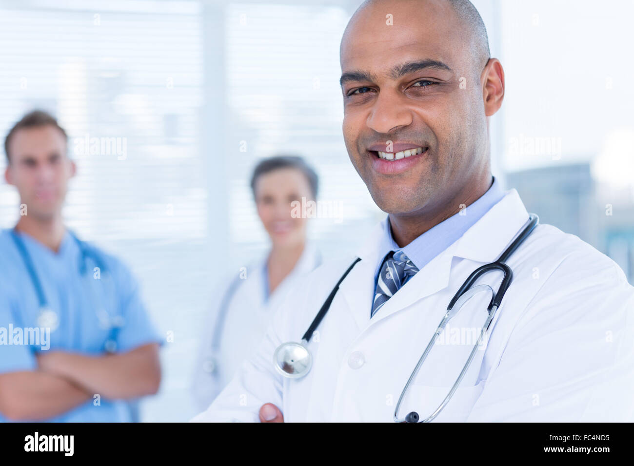 Smiling colleagues doctors looking at the camera Stock Photo - Alamy