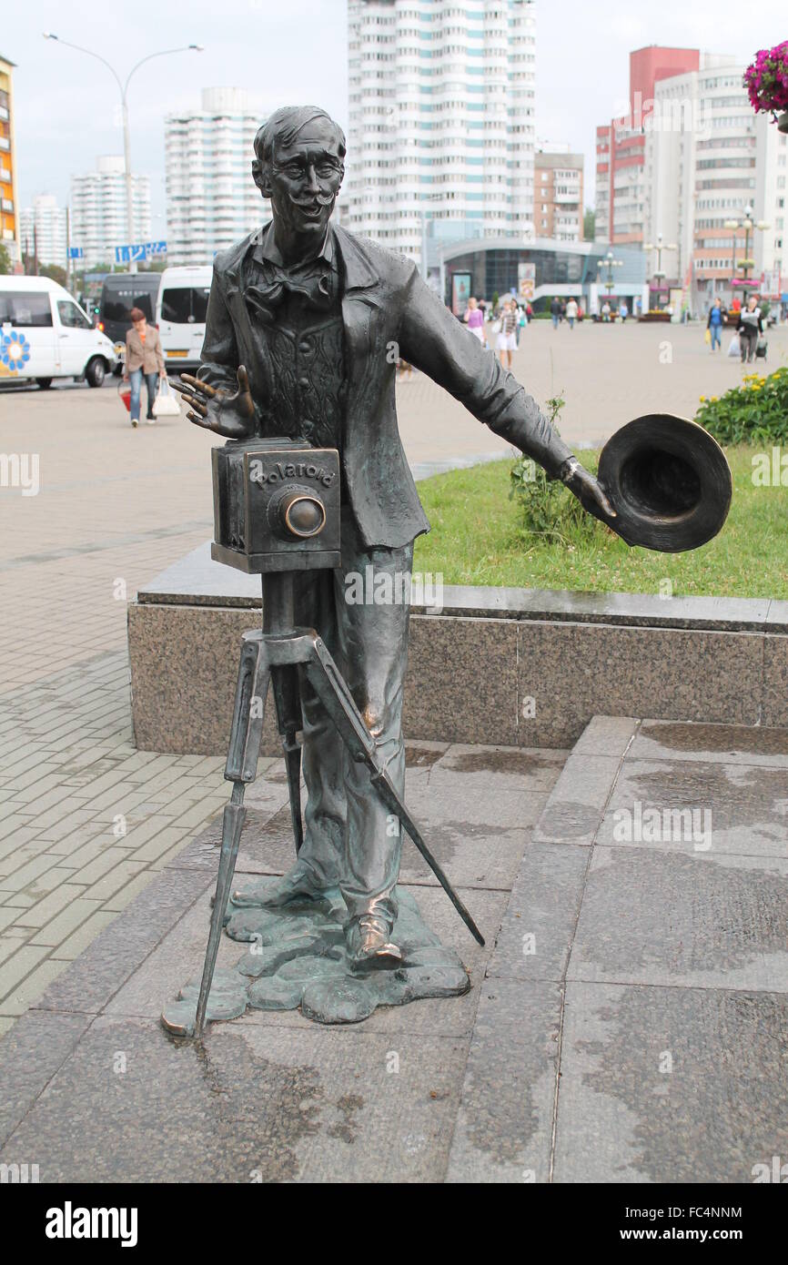 statue of retro style photographer in work stay on noisy city street ...