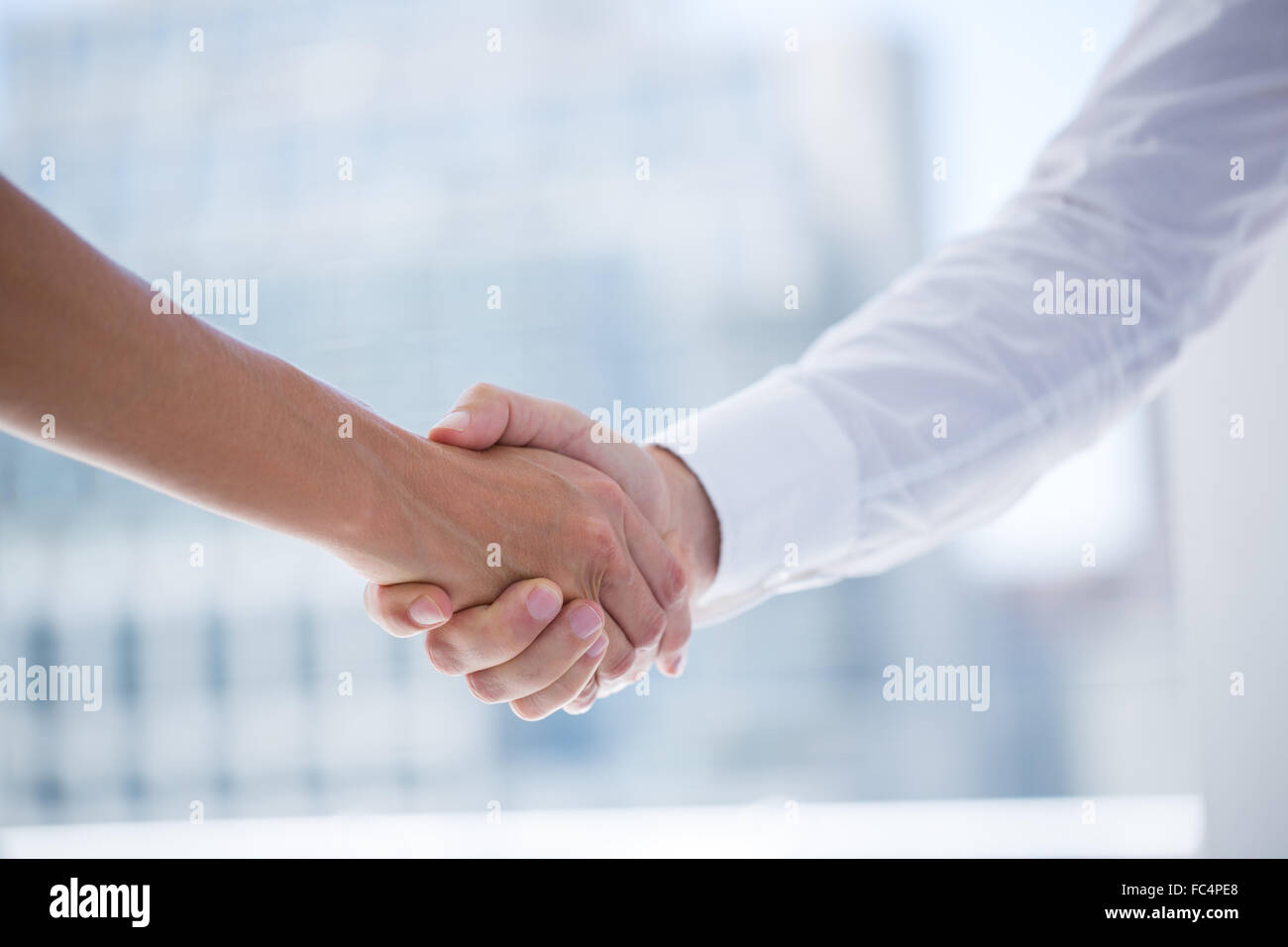 Close up view of two business people shaking hands Stock Photo - Alamy