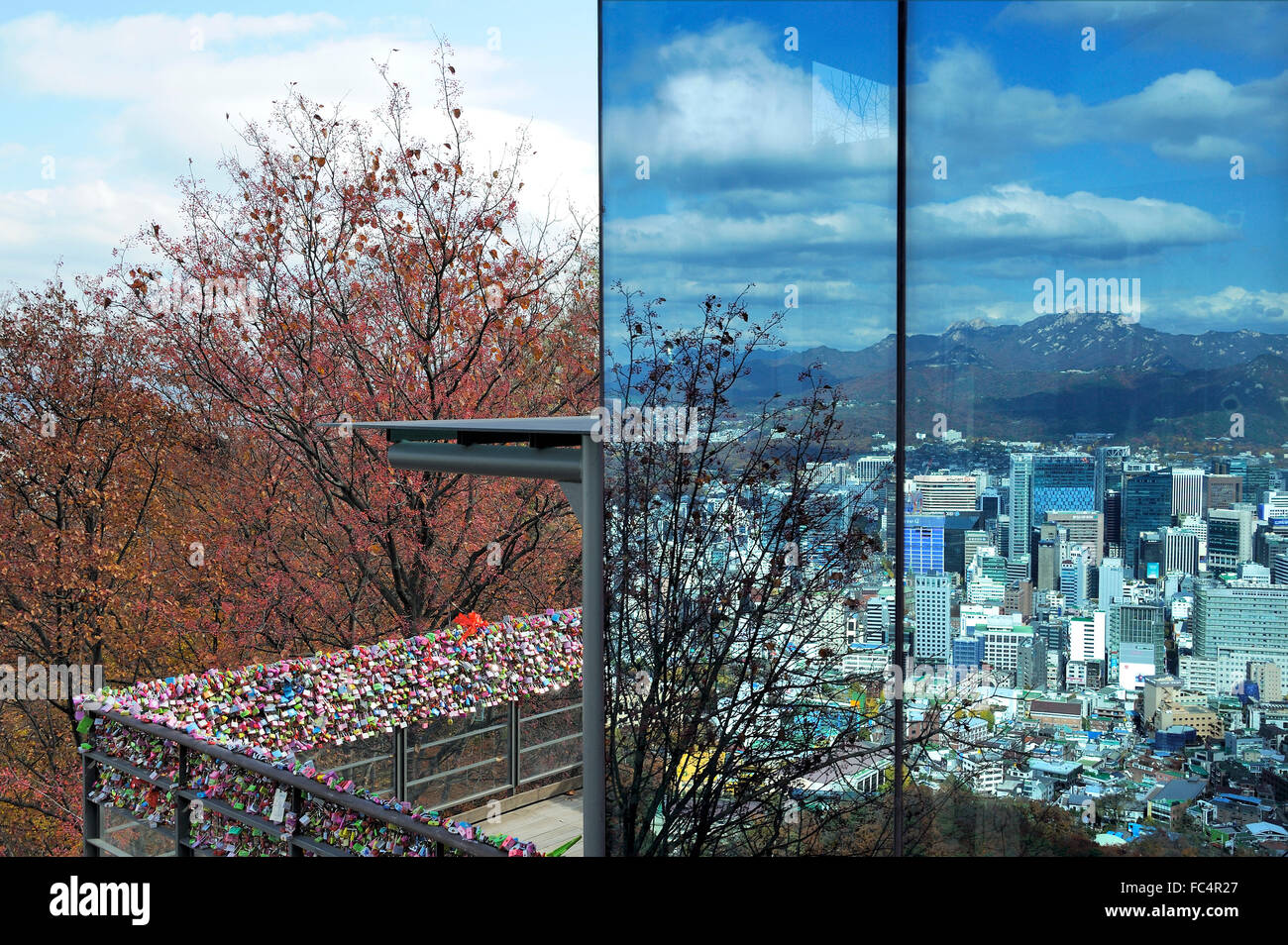 Seoul city in daylight reflected in the windows of Seoul Tower with at ...