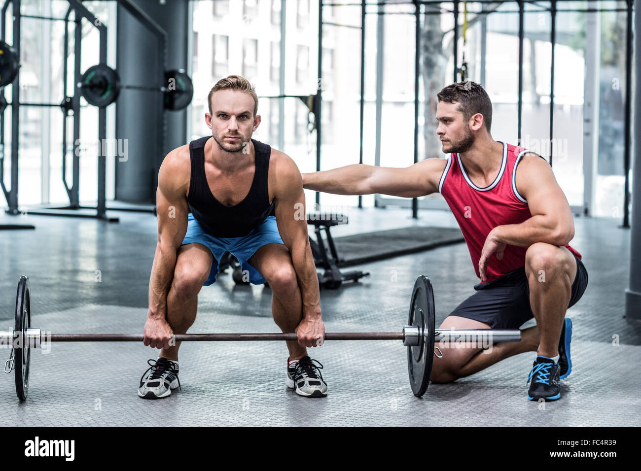 Portrait of a muscular man lifting a barbell Stock Photo - Alamy