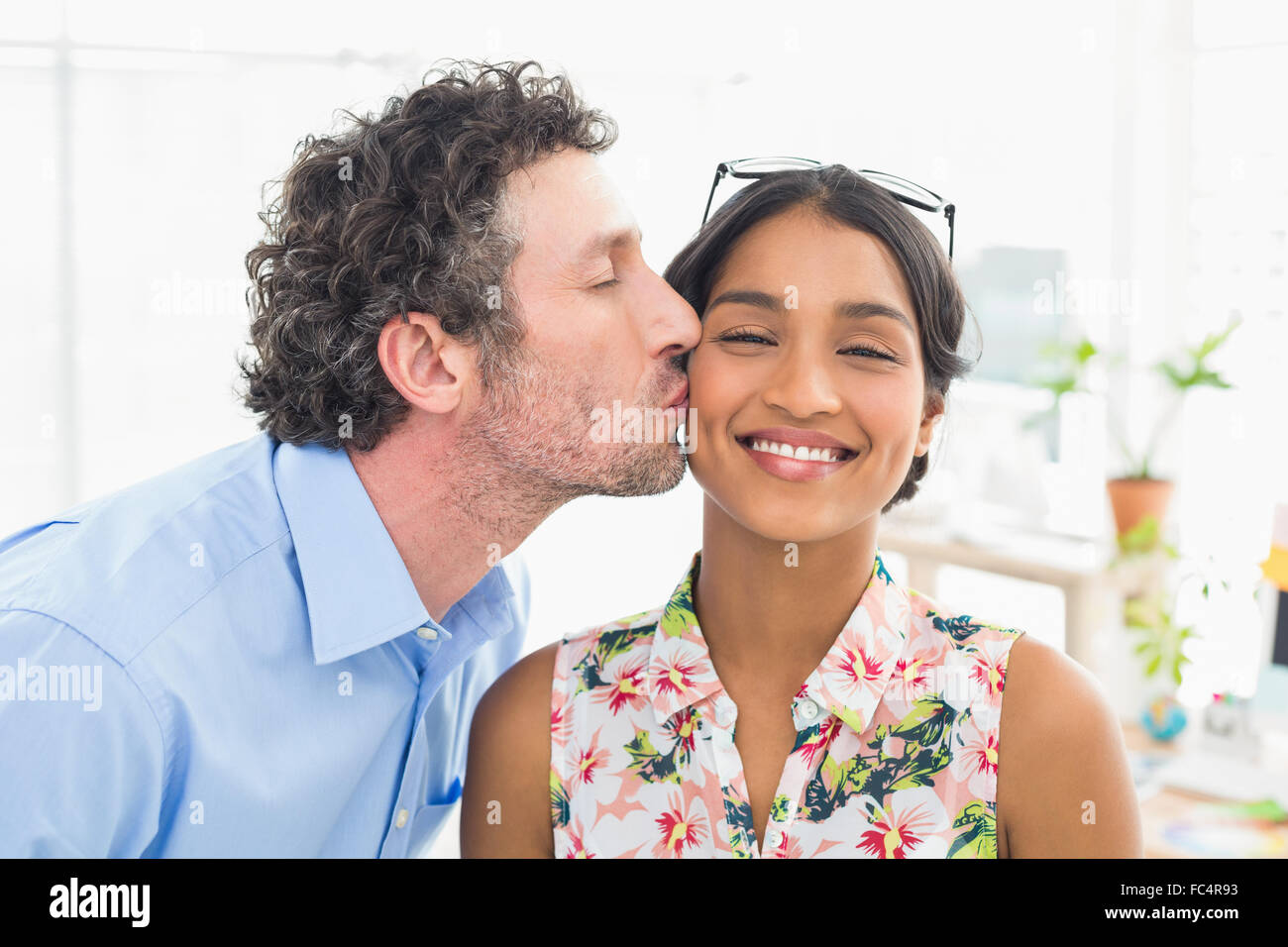 Portrait of a smiling casual young couple at work Stock Photo - Alamy