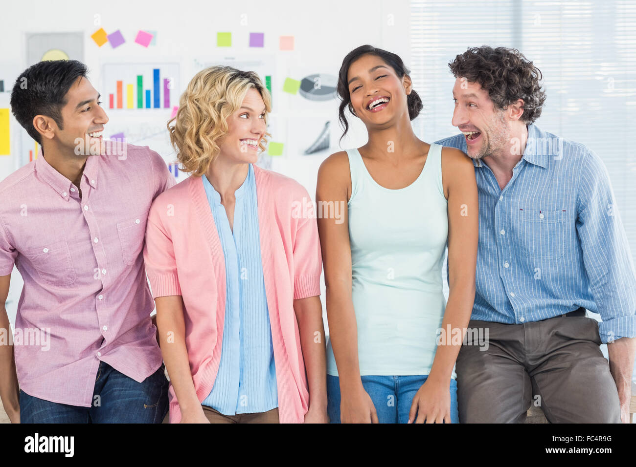 Smiling colleagues standing and posing in a line Stock Photo - Alamy