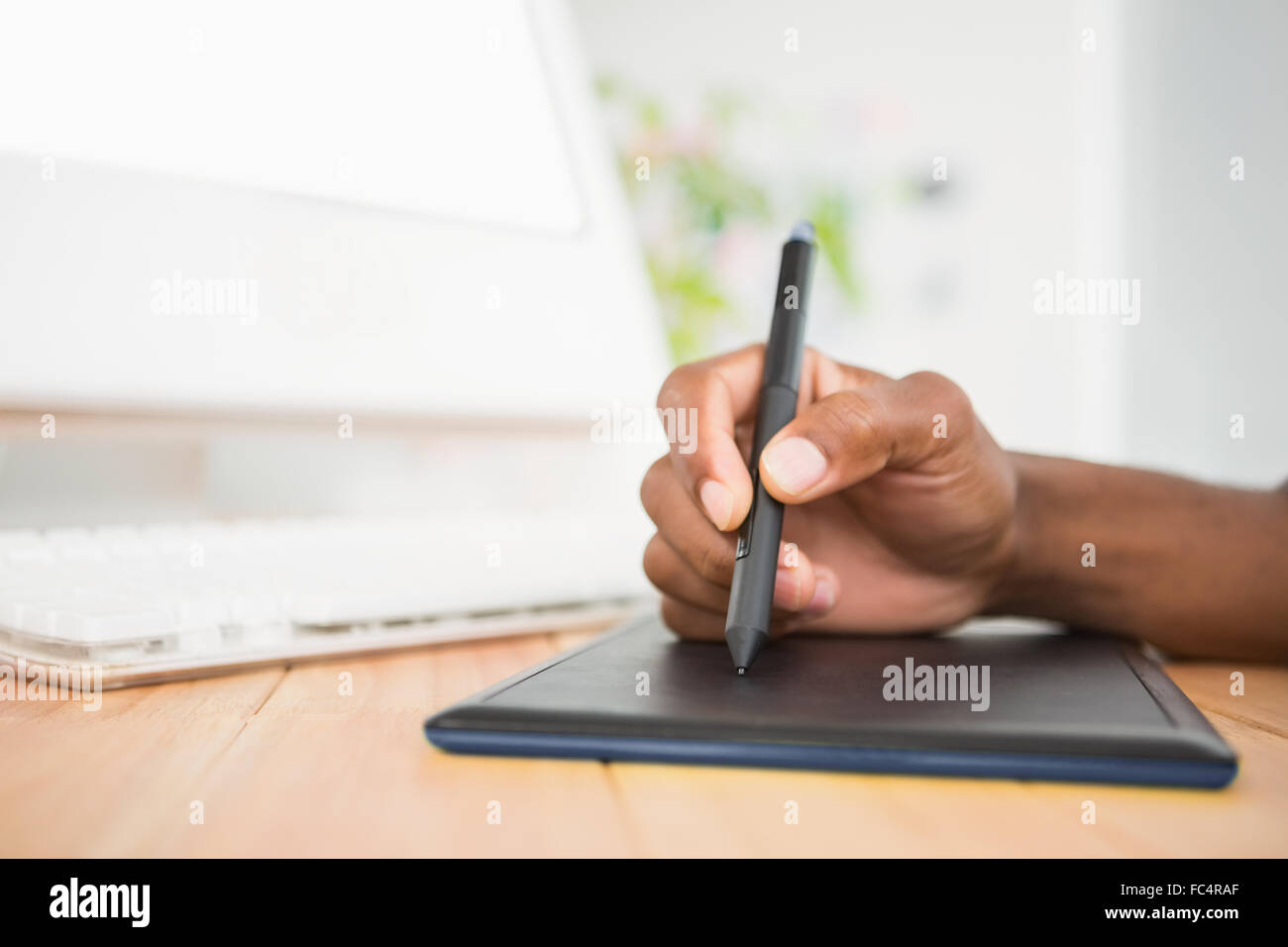 Young businessman writing on the graphic tablet Stock Photo - Alamy