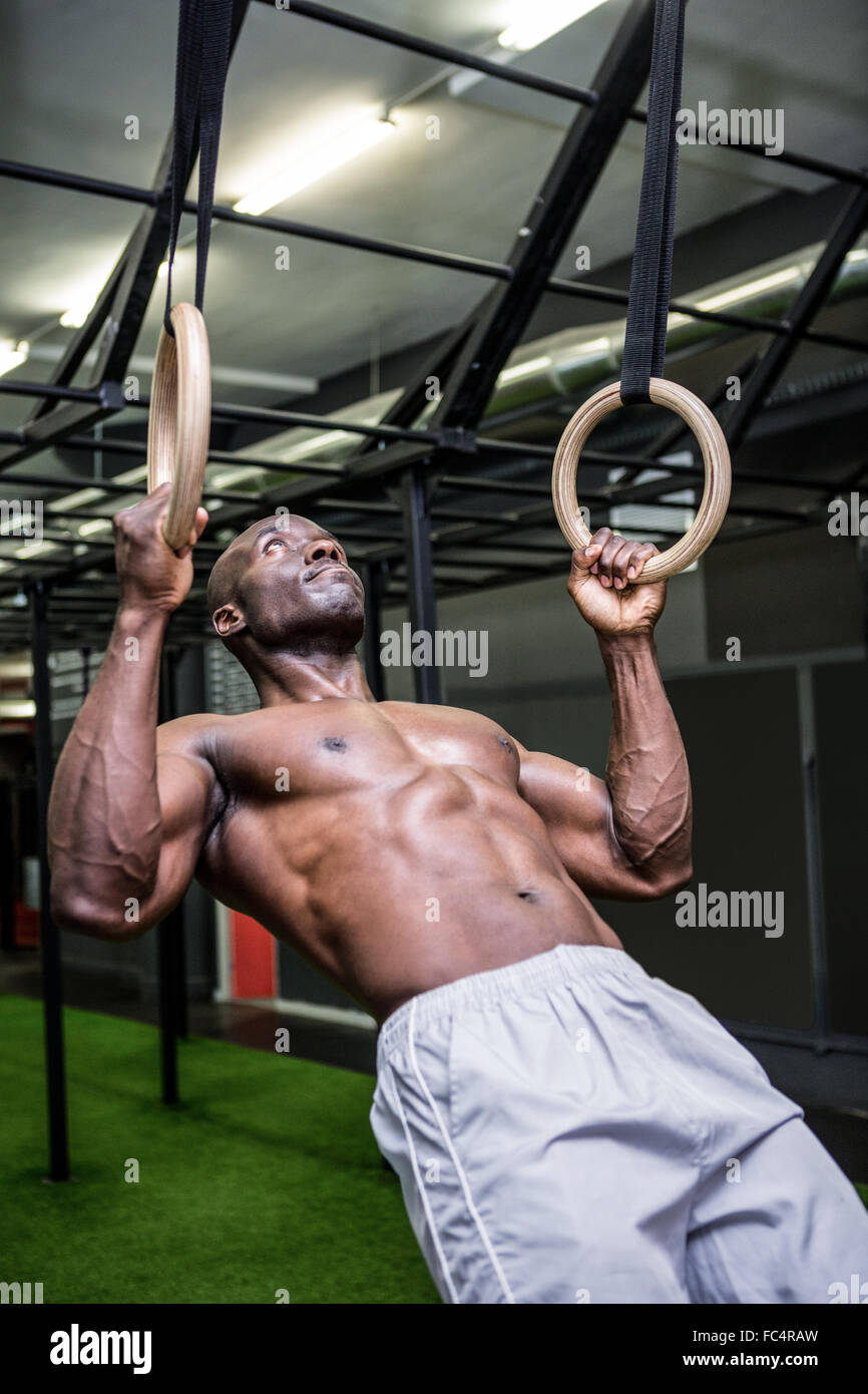 Young Bodybuilder lifting himself up and down Stock Photo - Alamy