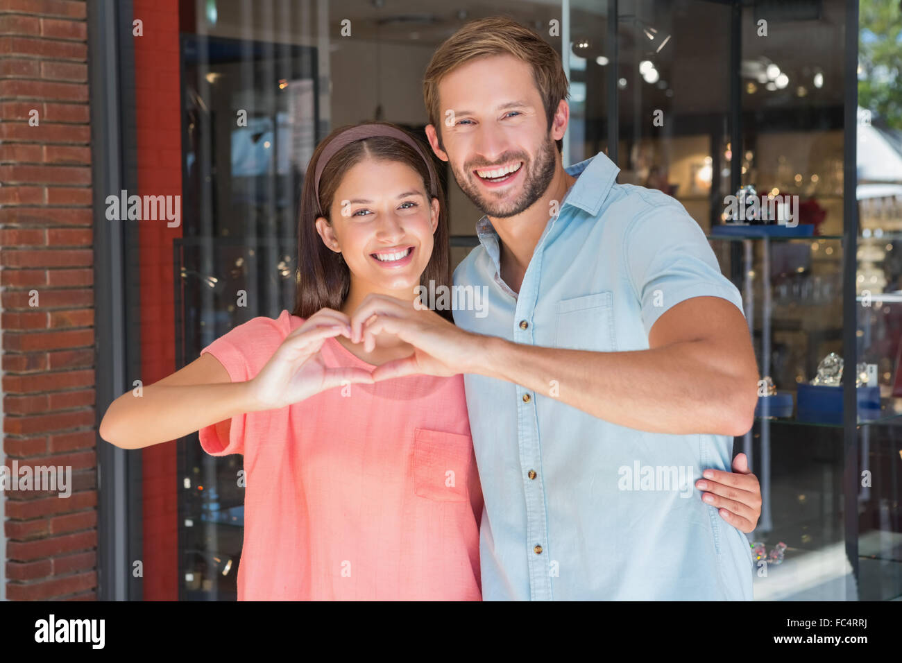Young happy couple making a heart with their hands Stock Photo - Alamy