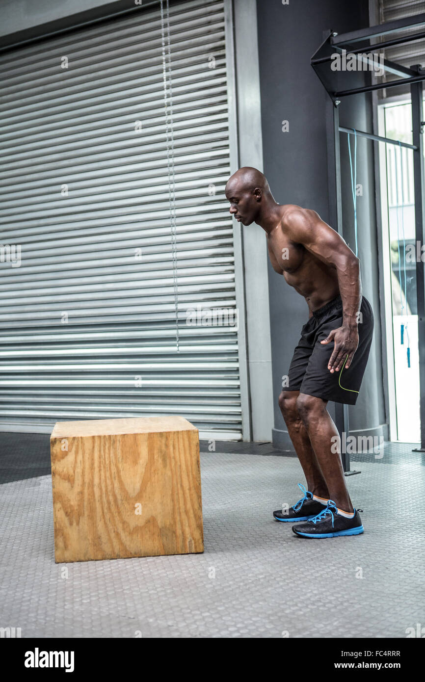 Young Bodybuilder standing in front of a wooden block Stock Photo - Alamy