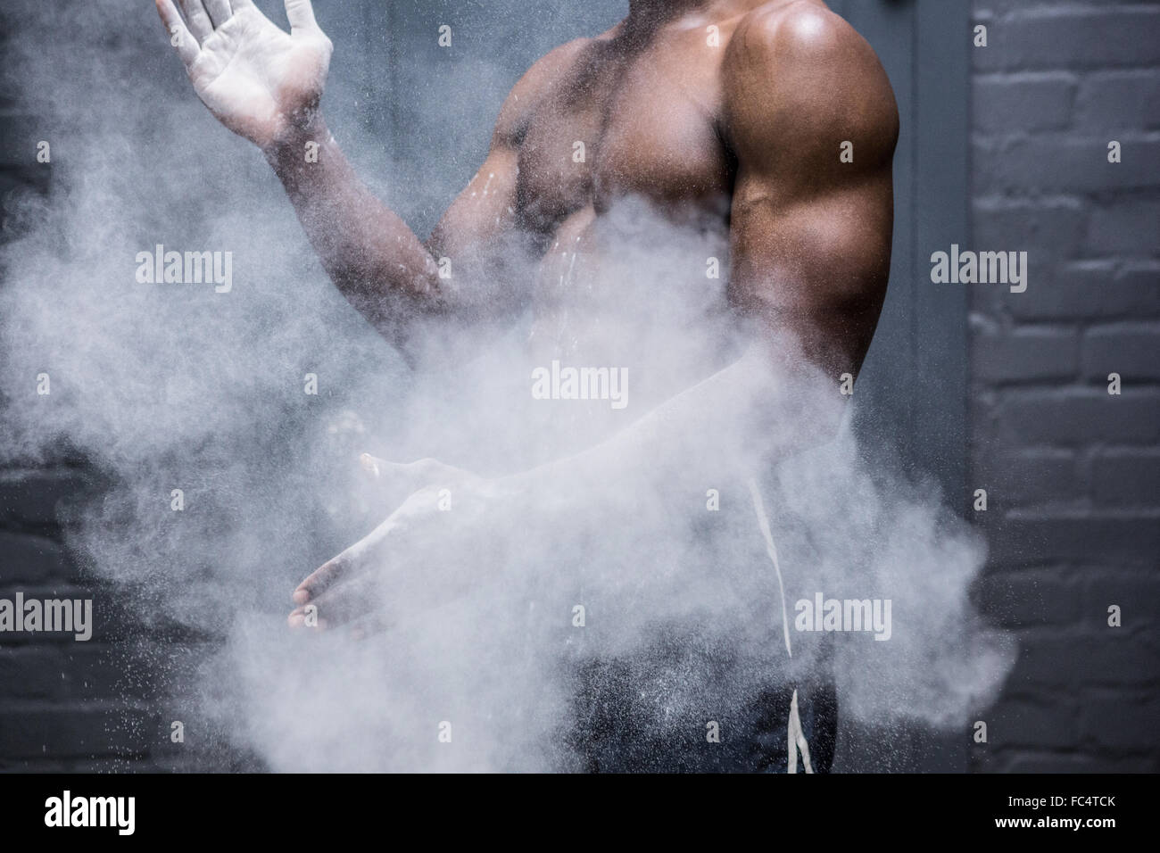 Young Bodybuilder shaking Chalk off his hands Stock Photo - Alamy