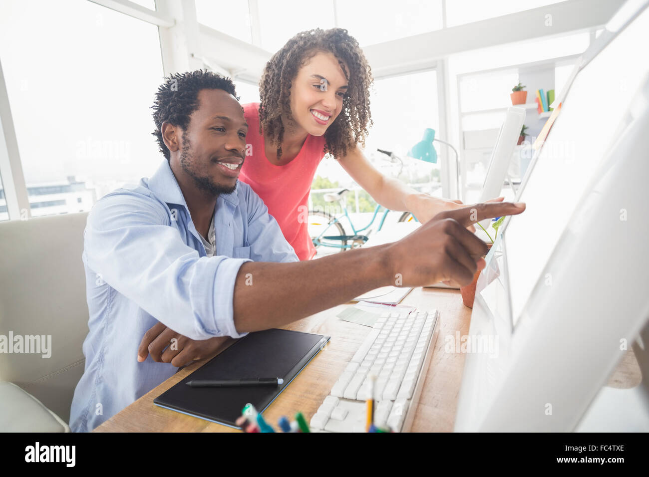 Two creative business colleagues watching the computer Stock Photo - Alamy