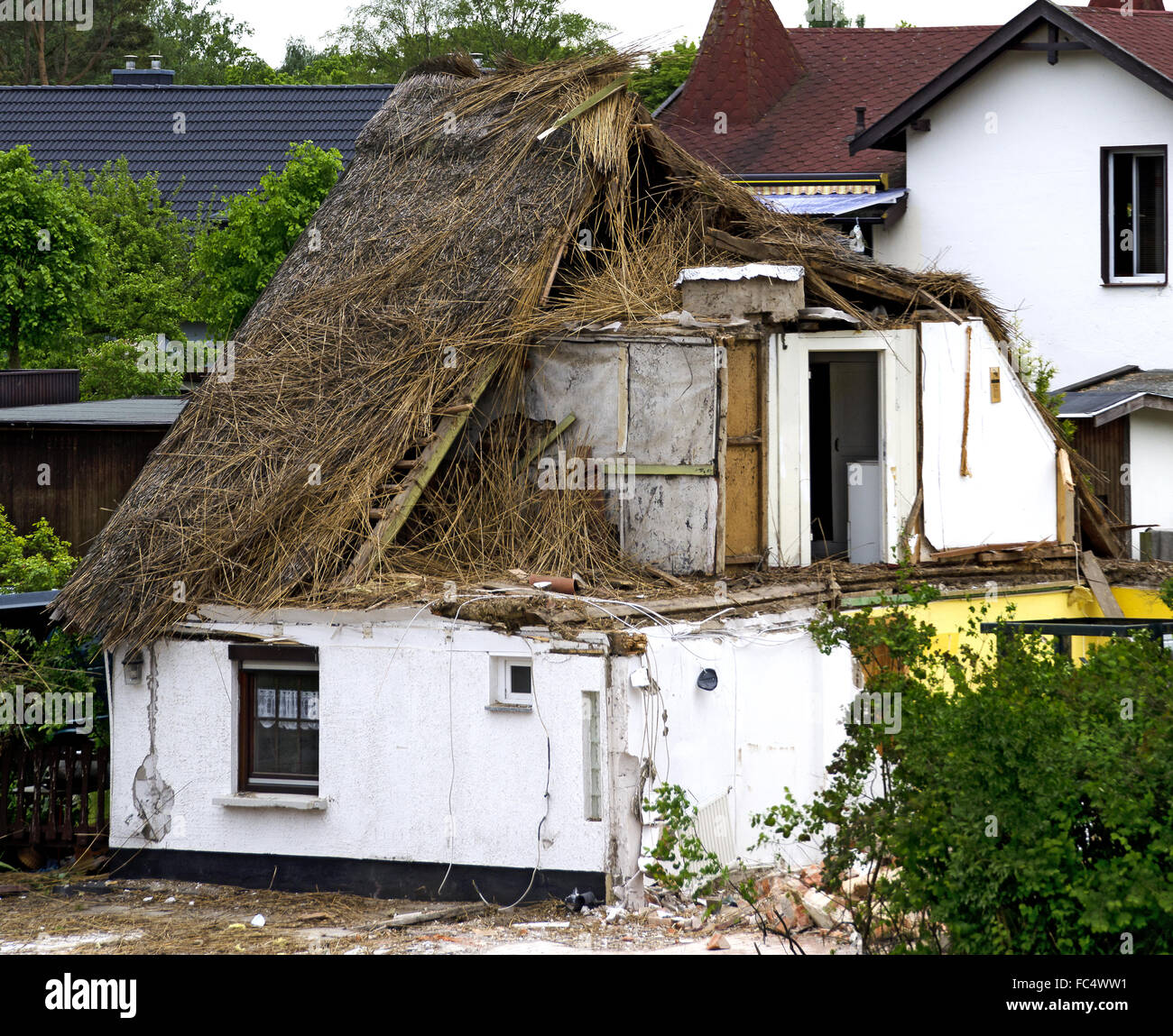 demolition of a reed covered house Stock Photo - Alamy