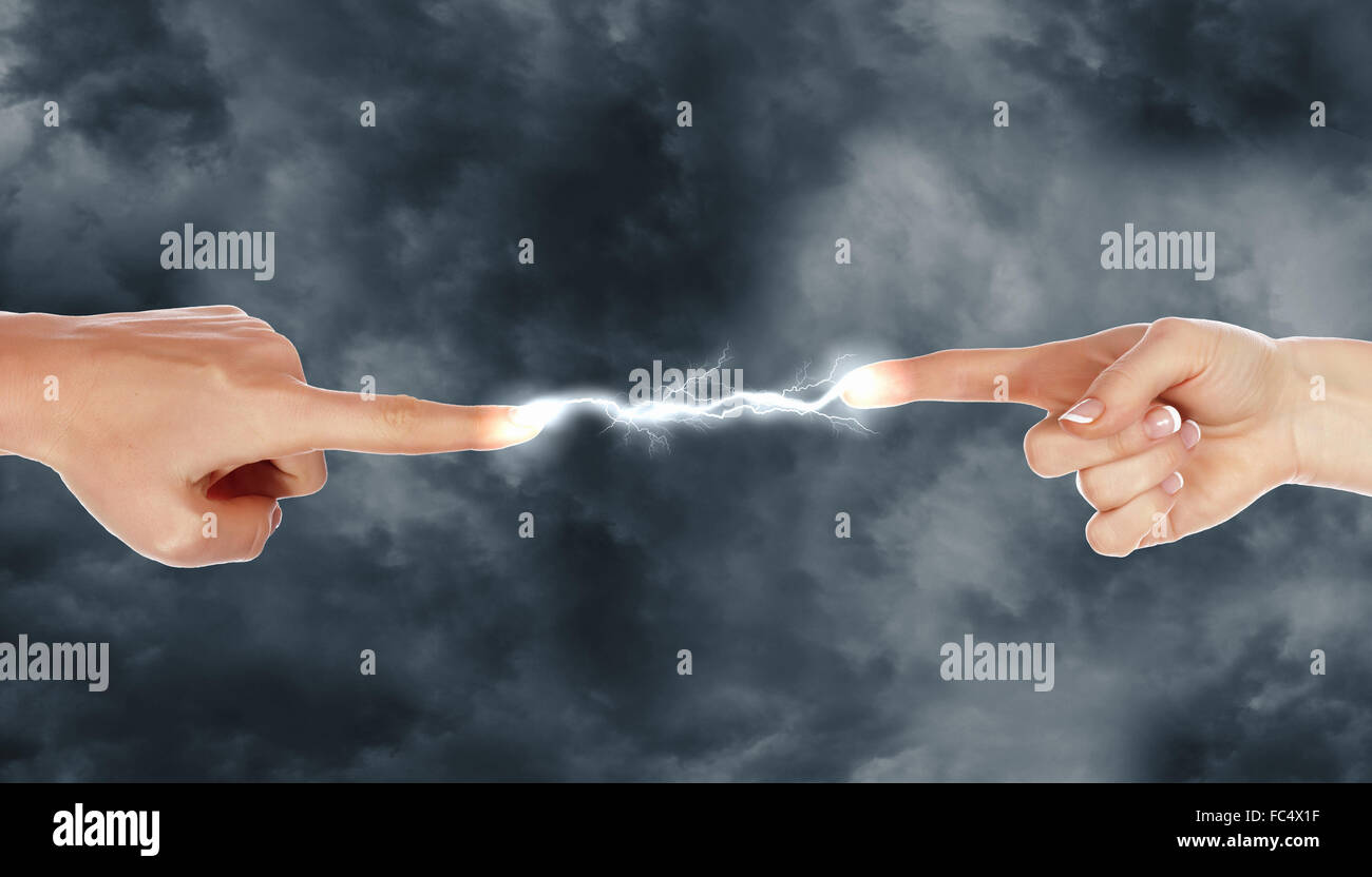 Two human hands in contact with bright flash Stock Photo - Alamy