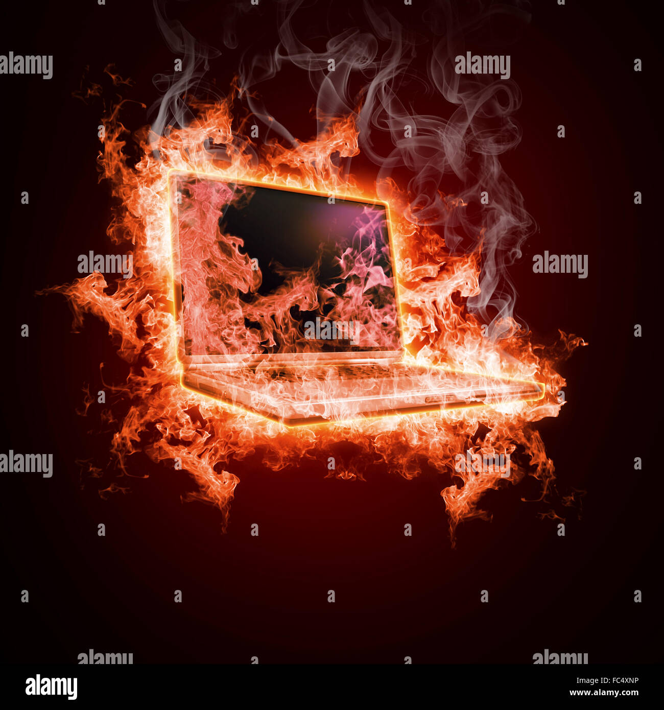 Laptop in open fire on a black background Stock Photo - Alamy