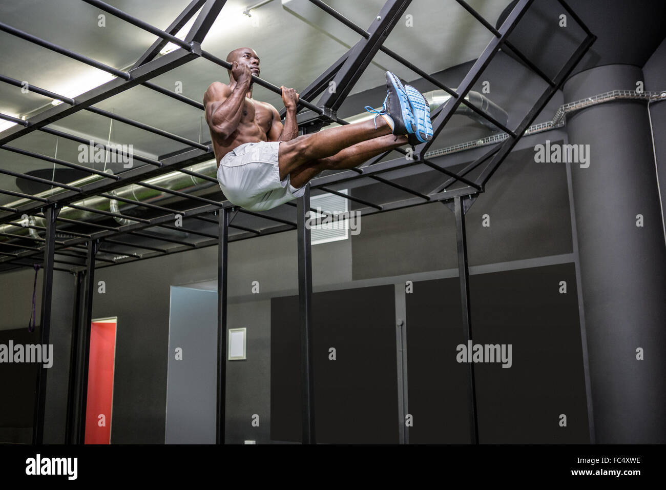 Young Bodybuilder lifting himself up and down Stock Photo - Alamy
