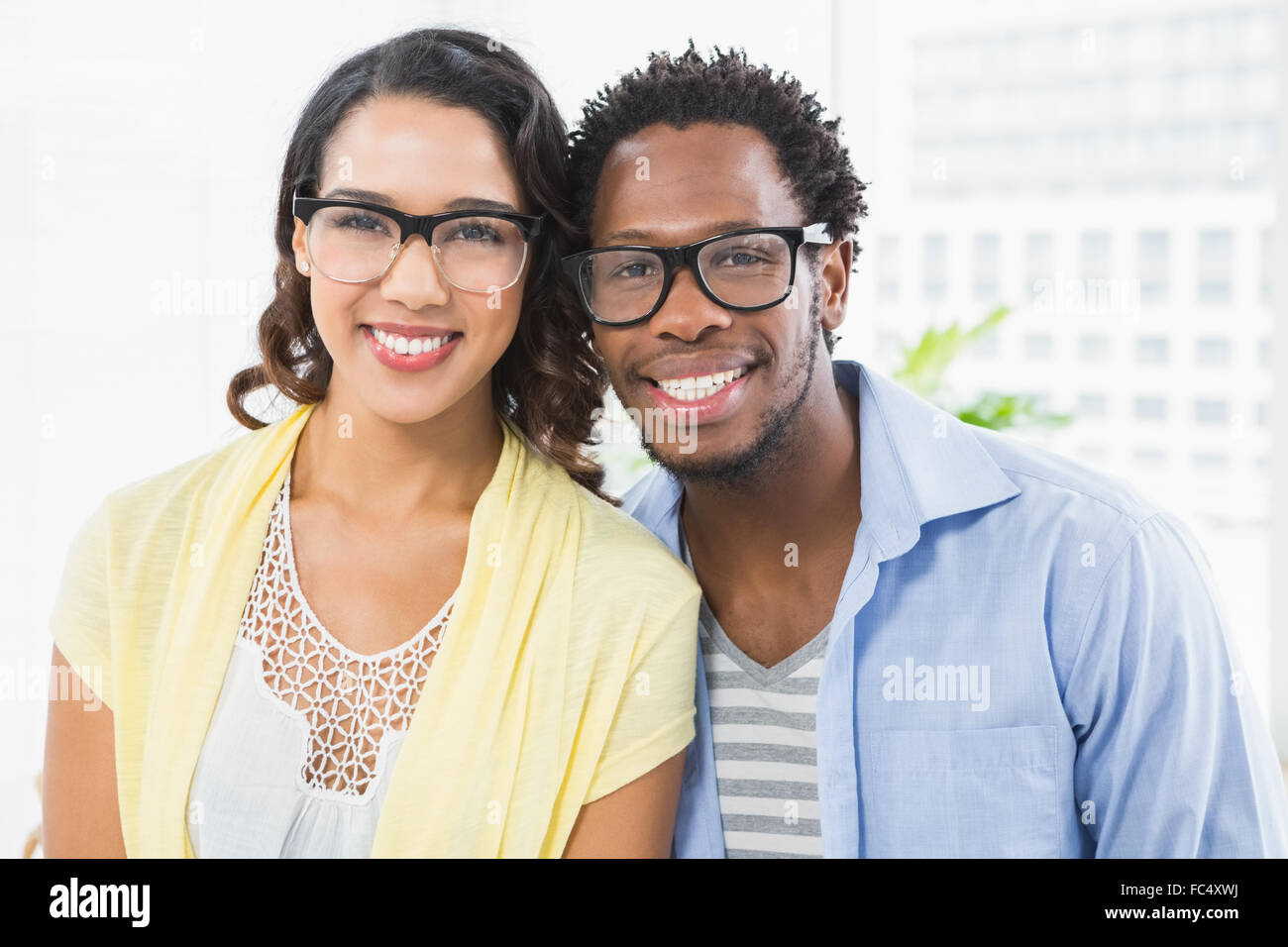 Portrait of casual business colleagues smiling together Stock Photo - Alamy