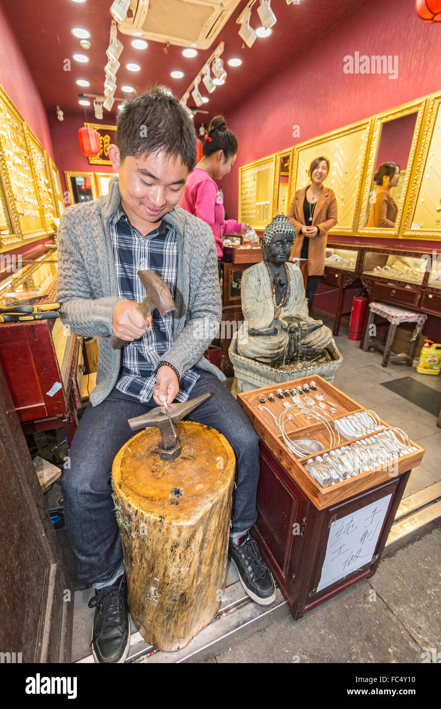 Craftsman makes silver jewelry in shop along Qinghefang Ancient Street ...