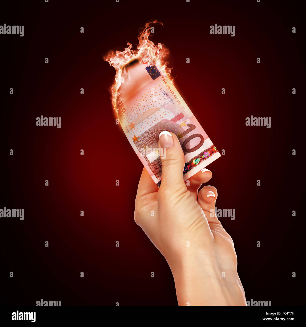 Banknotes open arms fire on a black background Stock Photo - Alamy