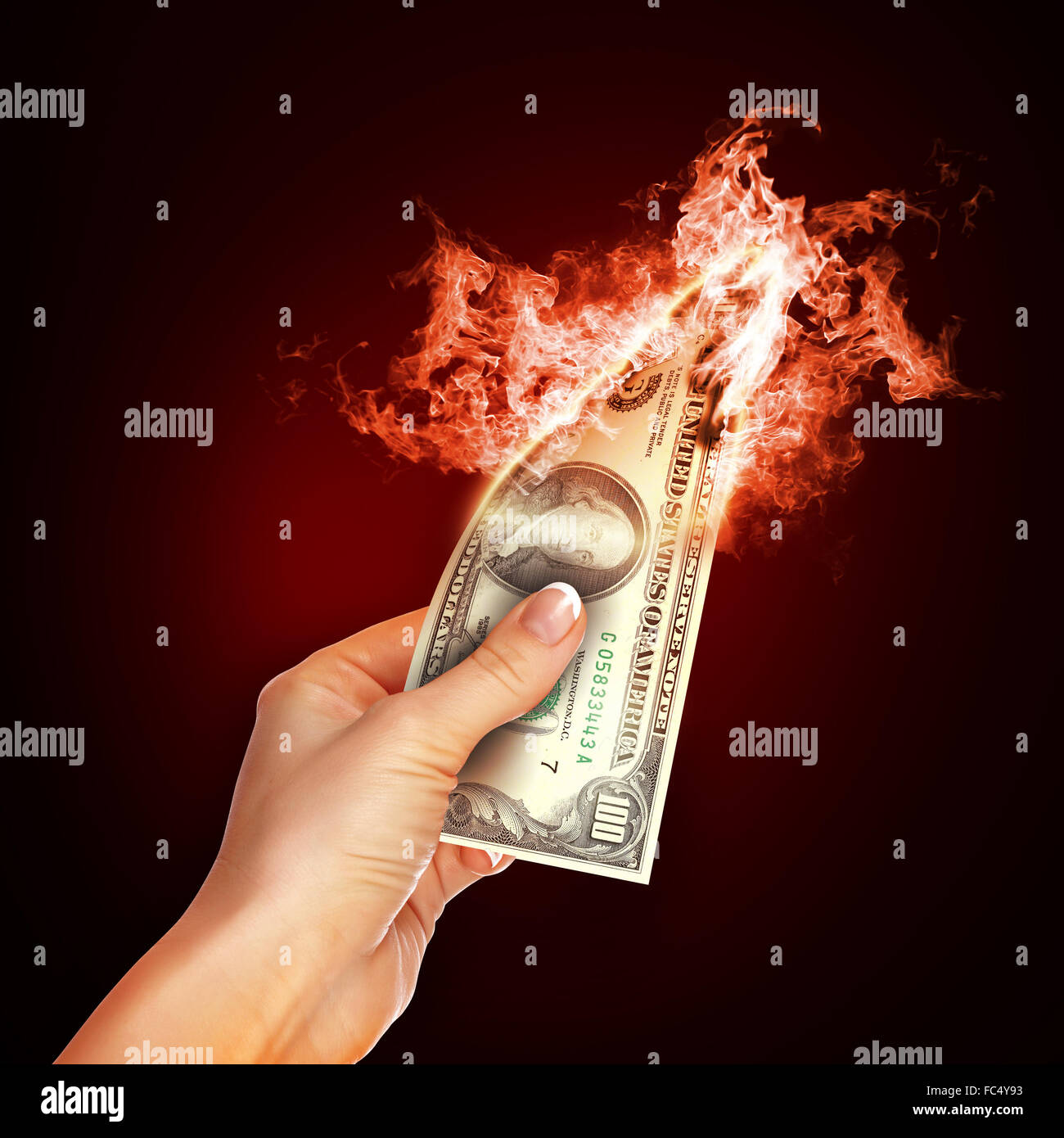 Banknotes open arms fire on a black background Stock Photo - Alamy