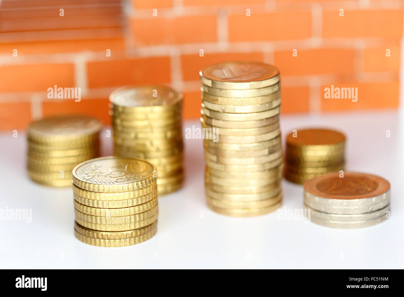coins and brick wall Stock Photo - Alamy