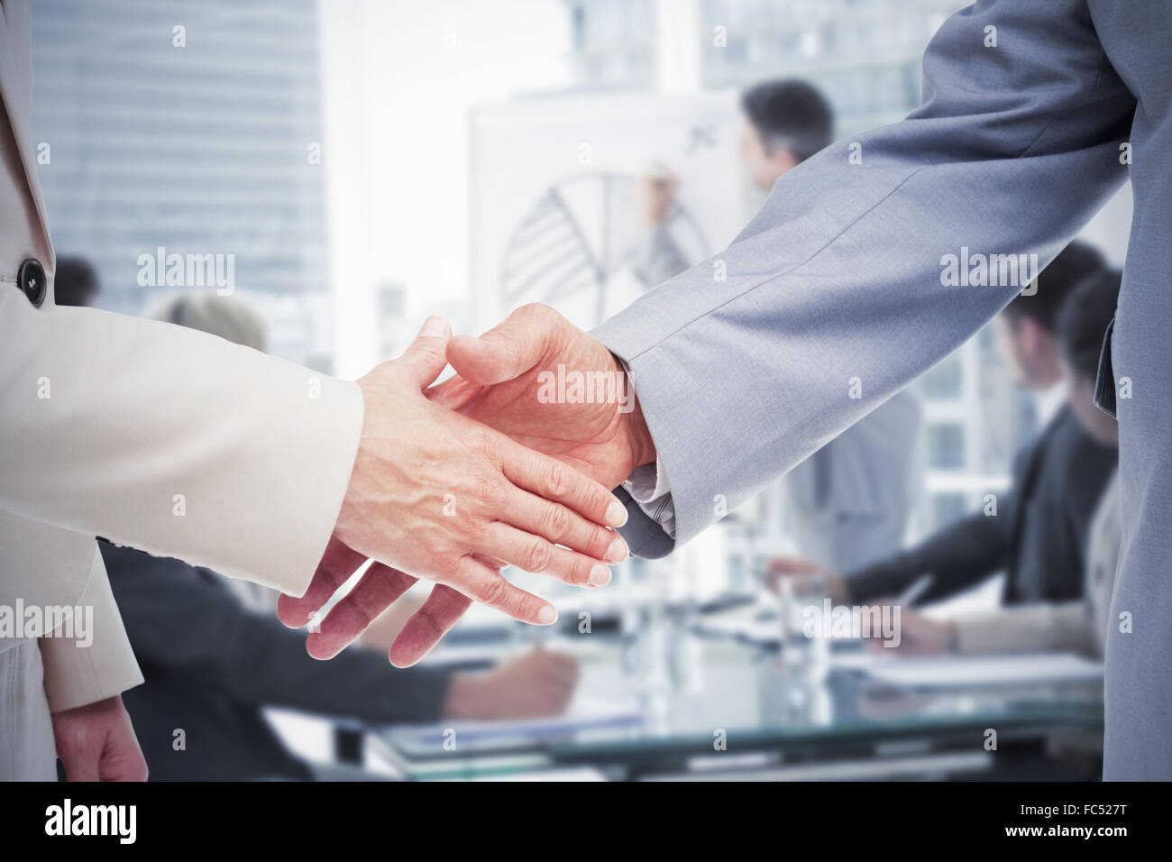 Composite image of close up of business people shaking their hands ...