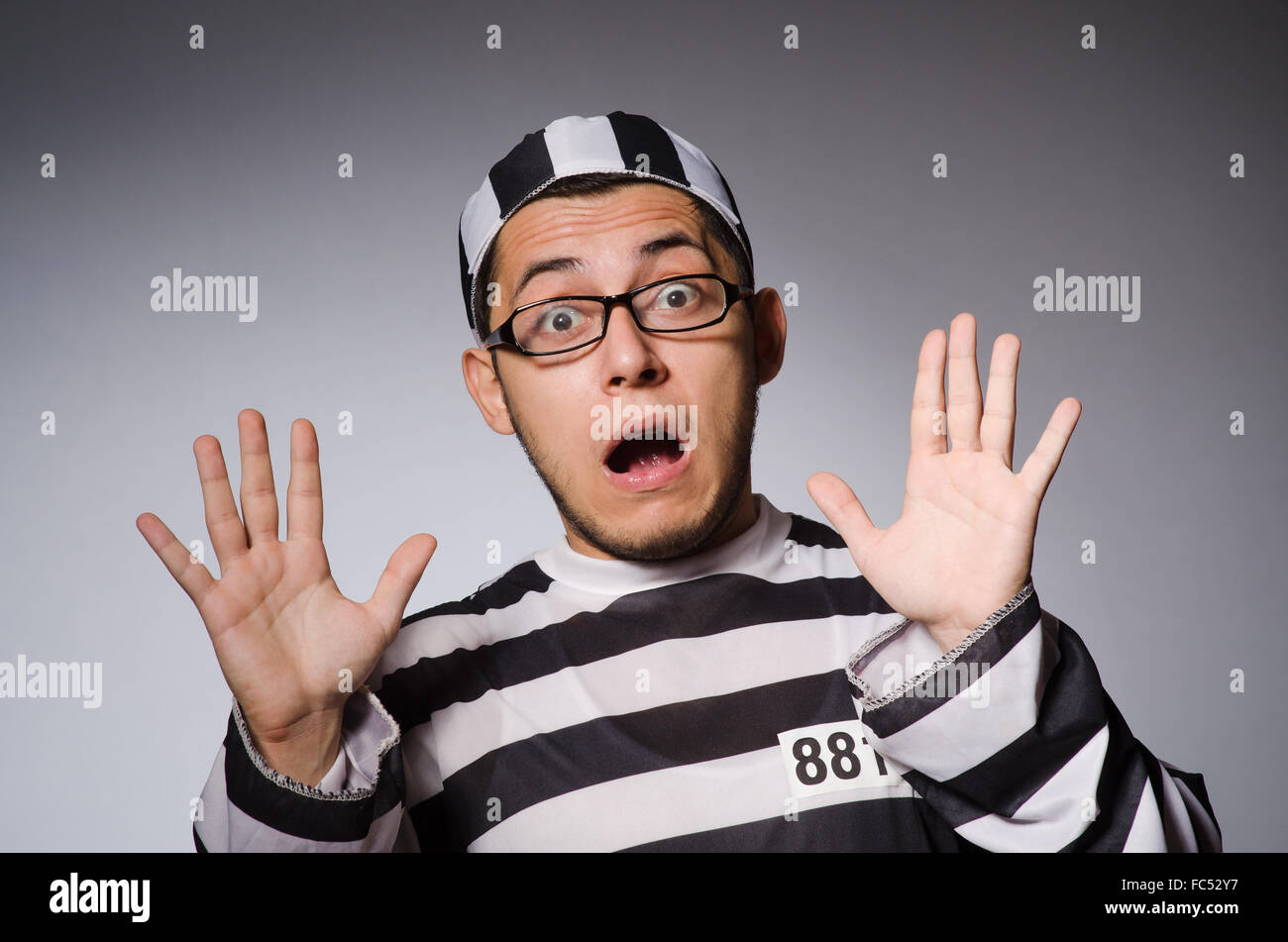 Funny prisoner isolated on gray Stock Photo - Alamy