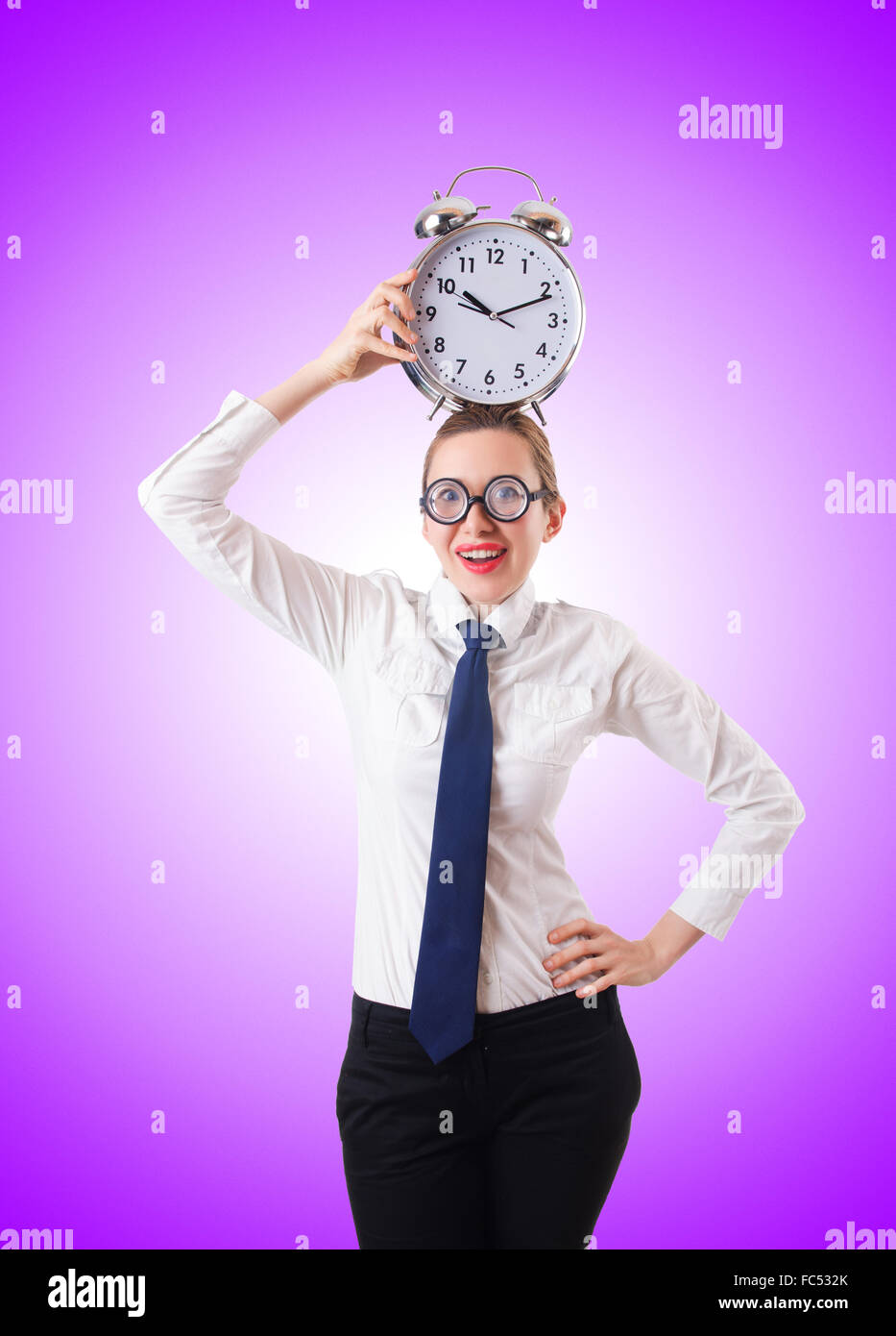 Nerd businesswoman with gian alarm clock Stock Photo - Alamy