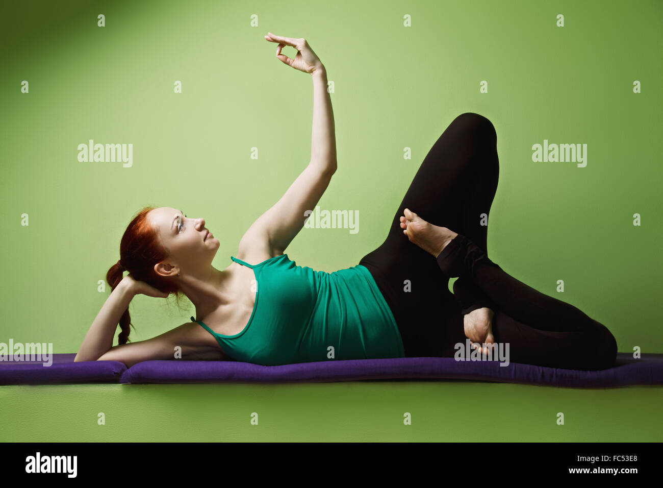 Yoga woman looking at hand Stock Photo - Alamy