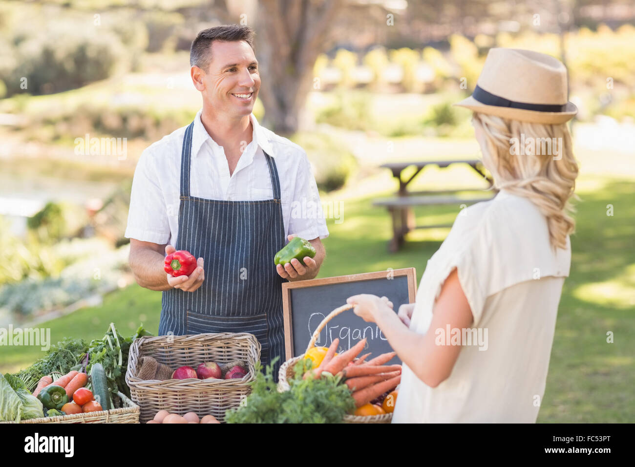Smiling farmer discussing with a blonde customer Stock Photo - Alamy