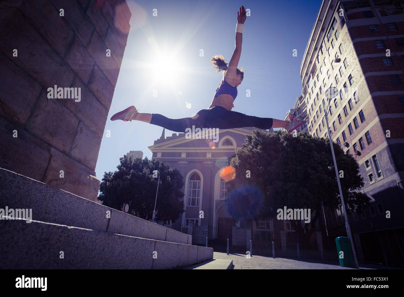Athletic woman jumping off the stairs and doing split in the air Stock ...