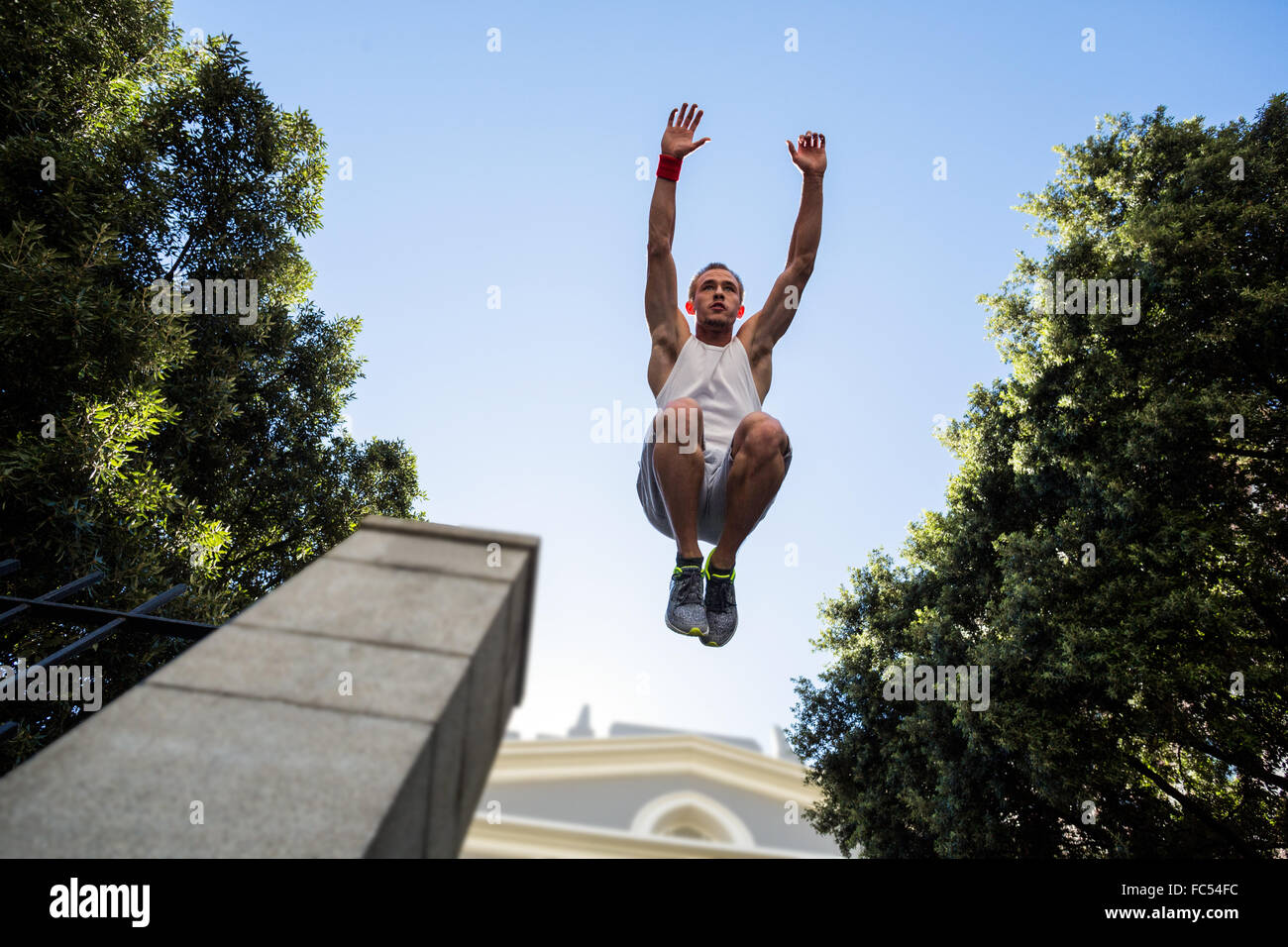 Extreme athlete jumping in the air in front of a building Stock Photo ...