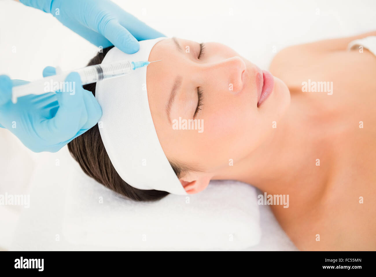 Woman receiving botox injection on her forehead Stock Photo - Alamy