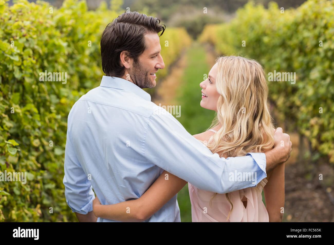 Young happy couple having an arm around each other and smiling Stock ...
