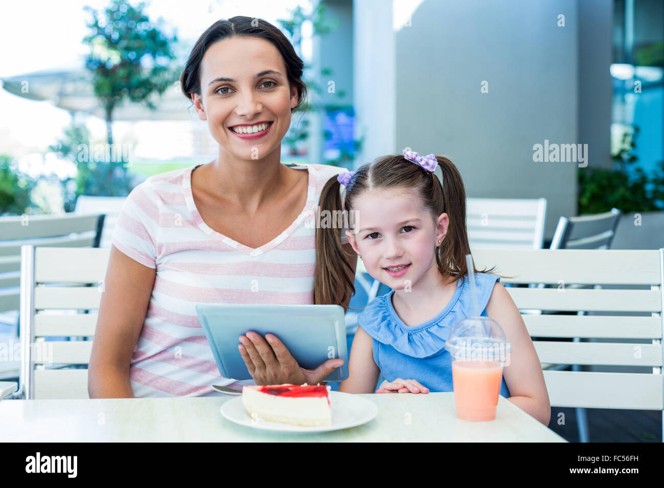 Mother and daughter using tablet computer together Stock Photo - Alamy