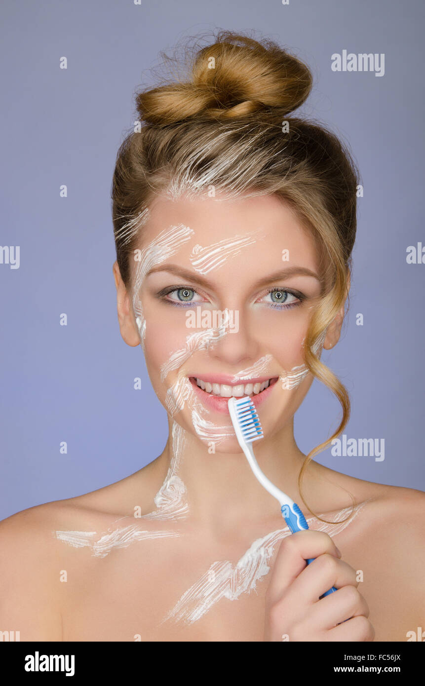smiling woman with toothbrush and toothpaste Stock Photo - Alamy